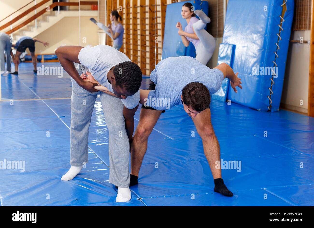 Two young men practicing self defense techniques in sports club Stock ...