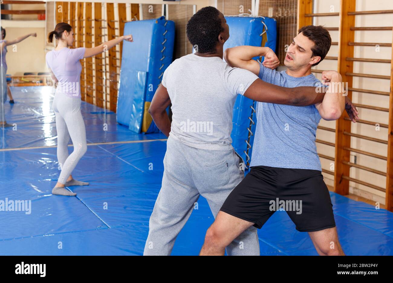 Men practicing effective techniques of self-defence during individual ...