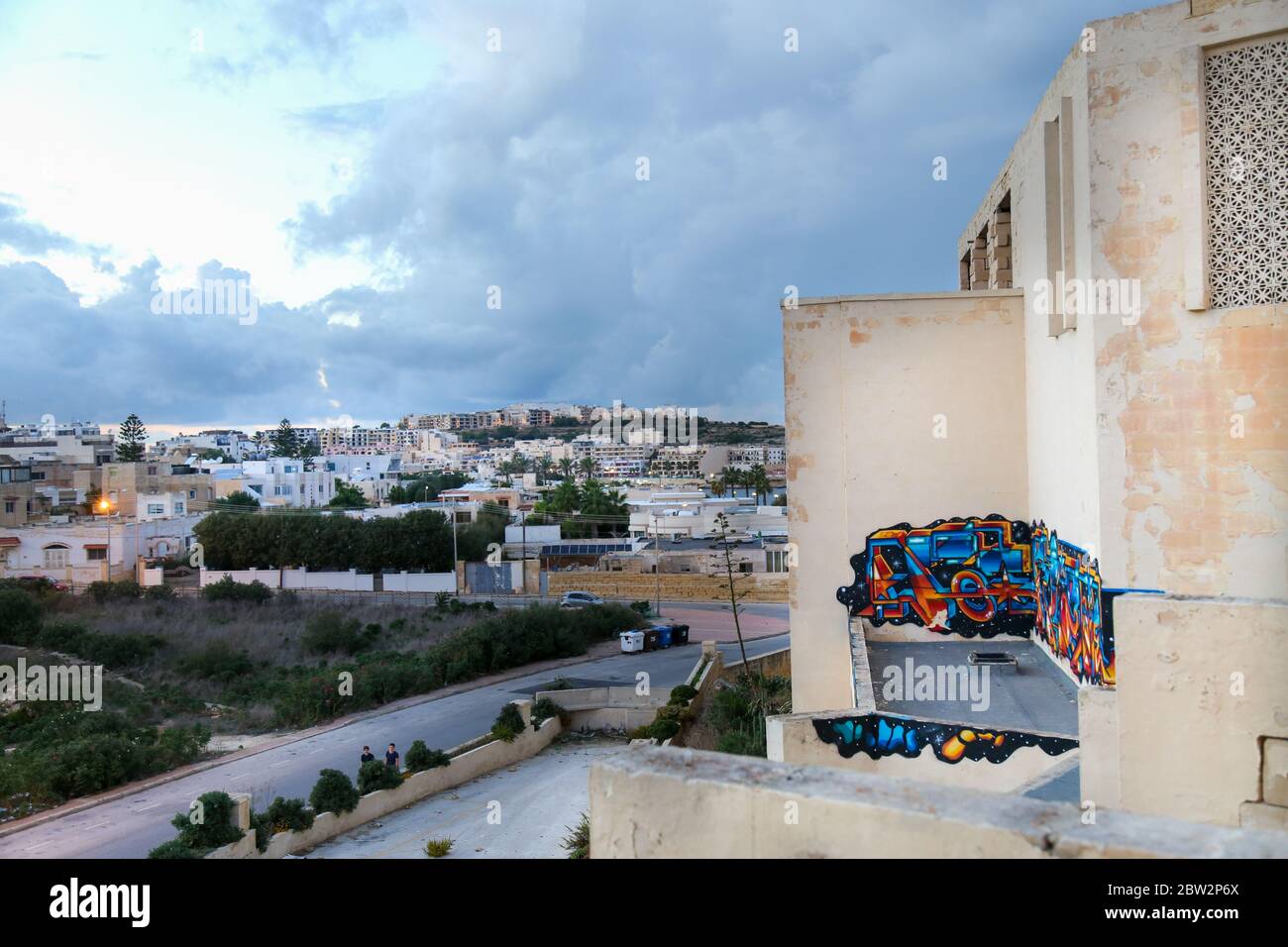 Exterior of an abandoned ruined building with the town of Marsaskala in ...