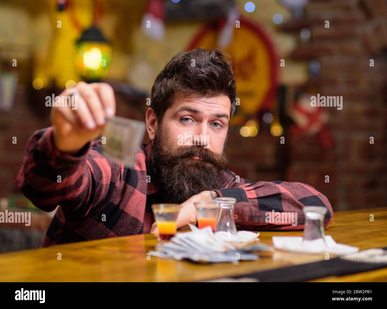 Hipster holds money, cash to buy more alcohol. Man with drunk face sit ...