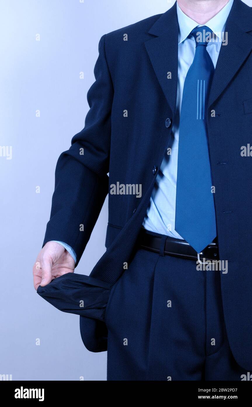 A man in a suit with empty pockets Stock Photo - Alamy