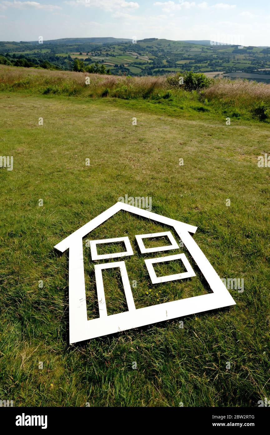 A house shape positioned on a plot of land Stock Photo - Alamy