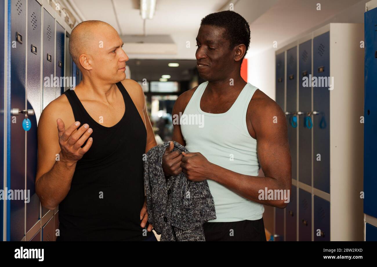 Two athletes in the locker room after training Stock Photo - Alamy