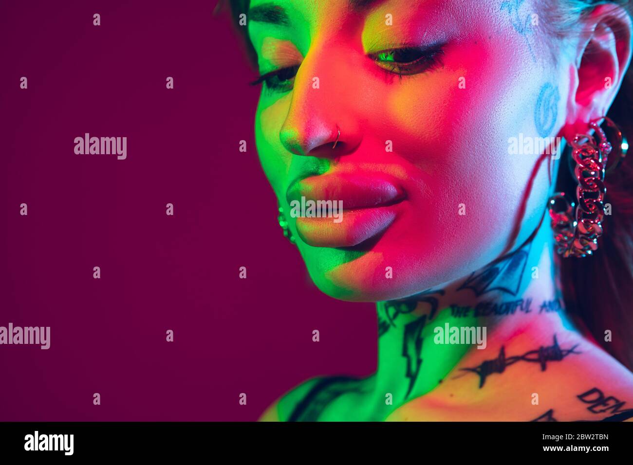 Close up portrait of young caucasian woman on purple studio background ...