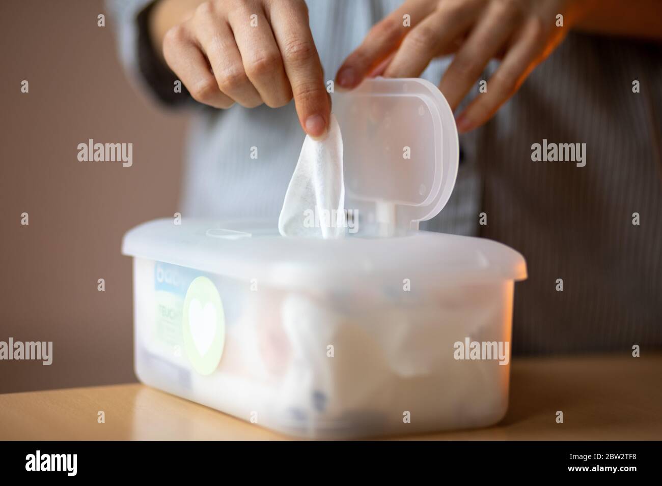 Wet wipes are universal an practical: woman hand take one wipe from big ...