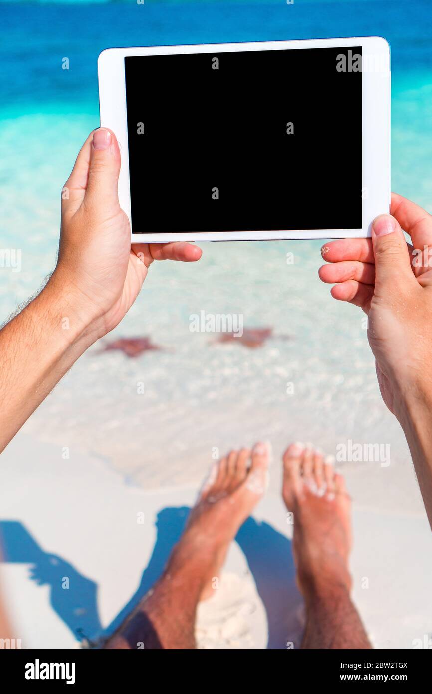 Man with tablet on the beach working Stock Photo - Alamy