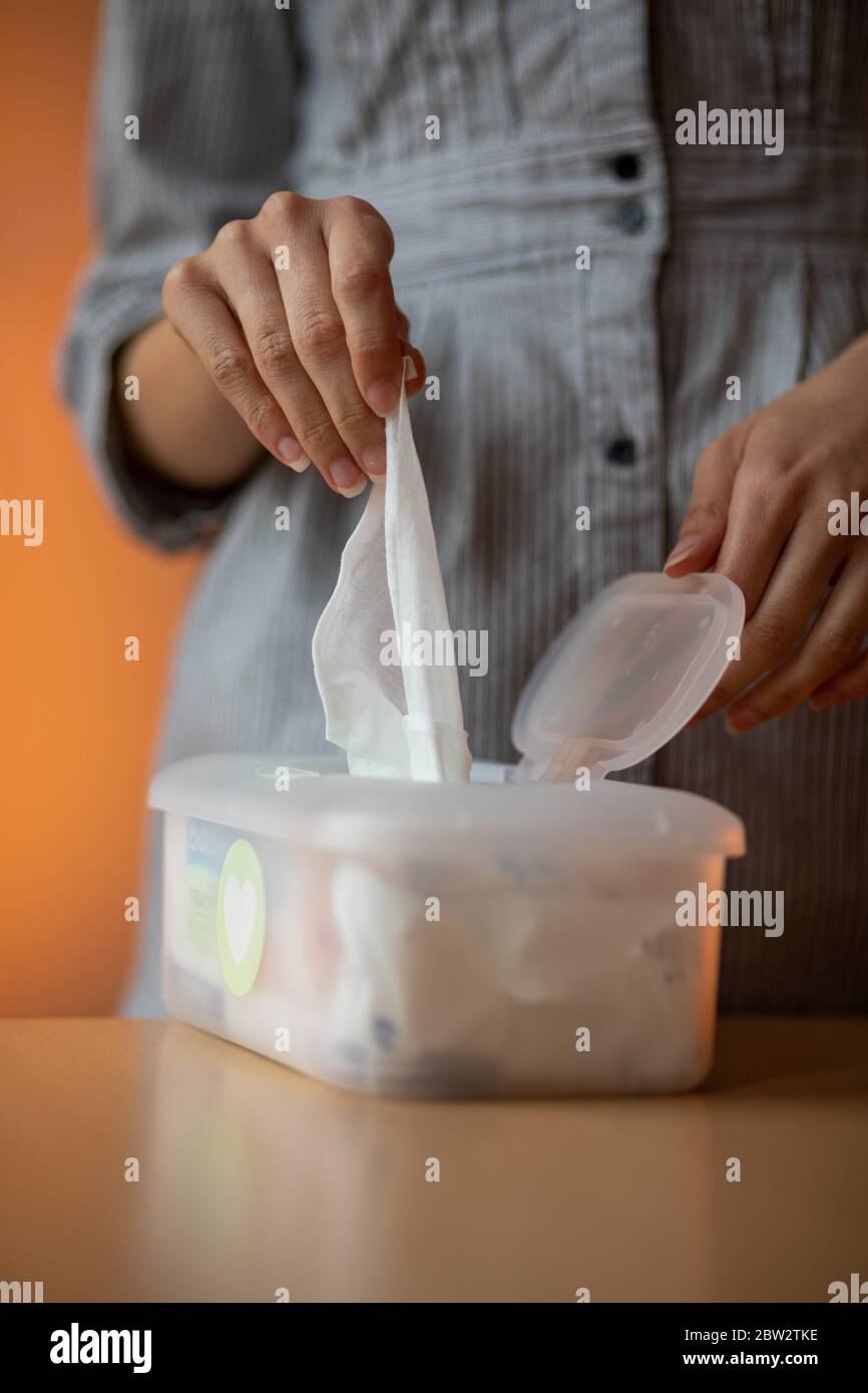 Wet wipes are universal an practical: woman hand take one wipe from big ...