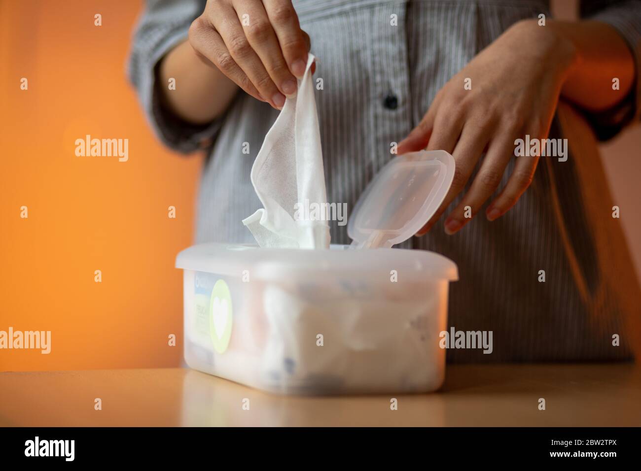 Wet wipes are universal an practical: woman hand take one wipe from big ...
