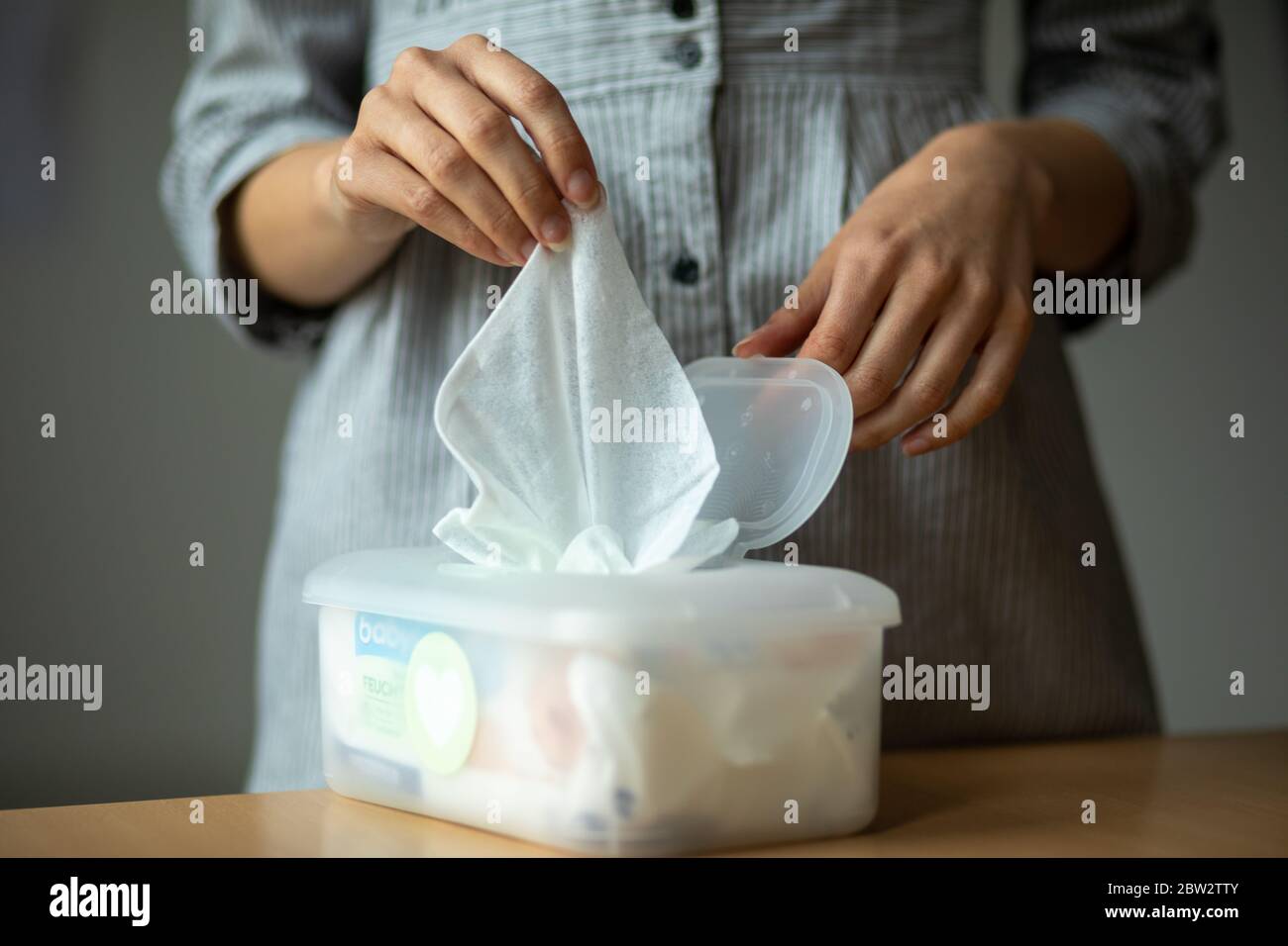 Wet wipes are universal an practical: woman hand take one wipe from big ...