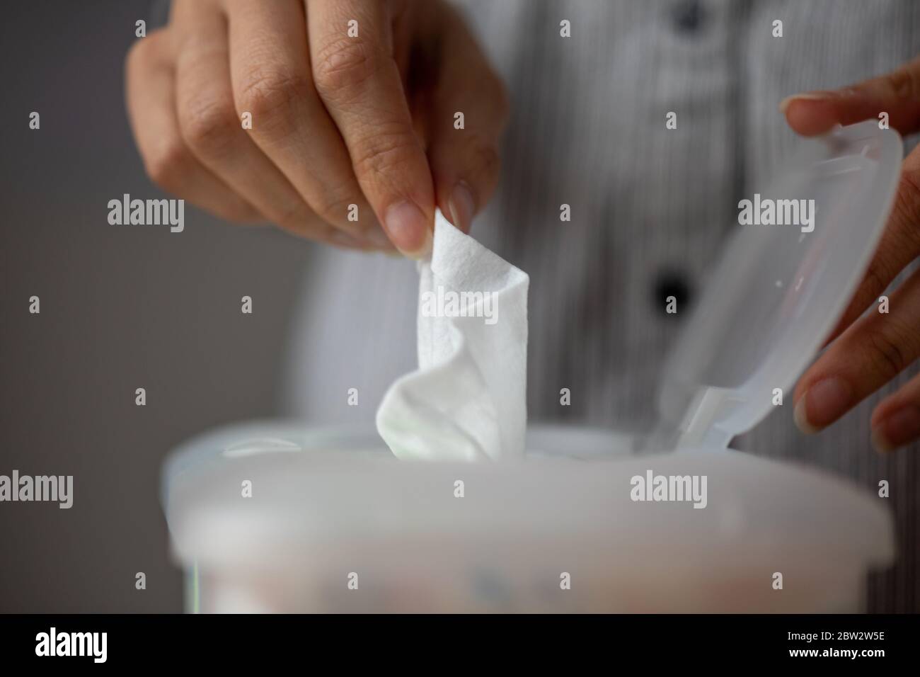 Wet wipes are universal an practical: woman hand take one wipe from big ...