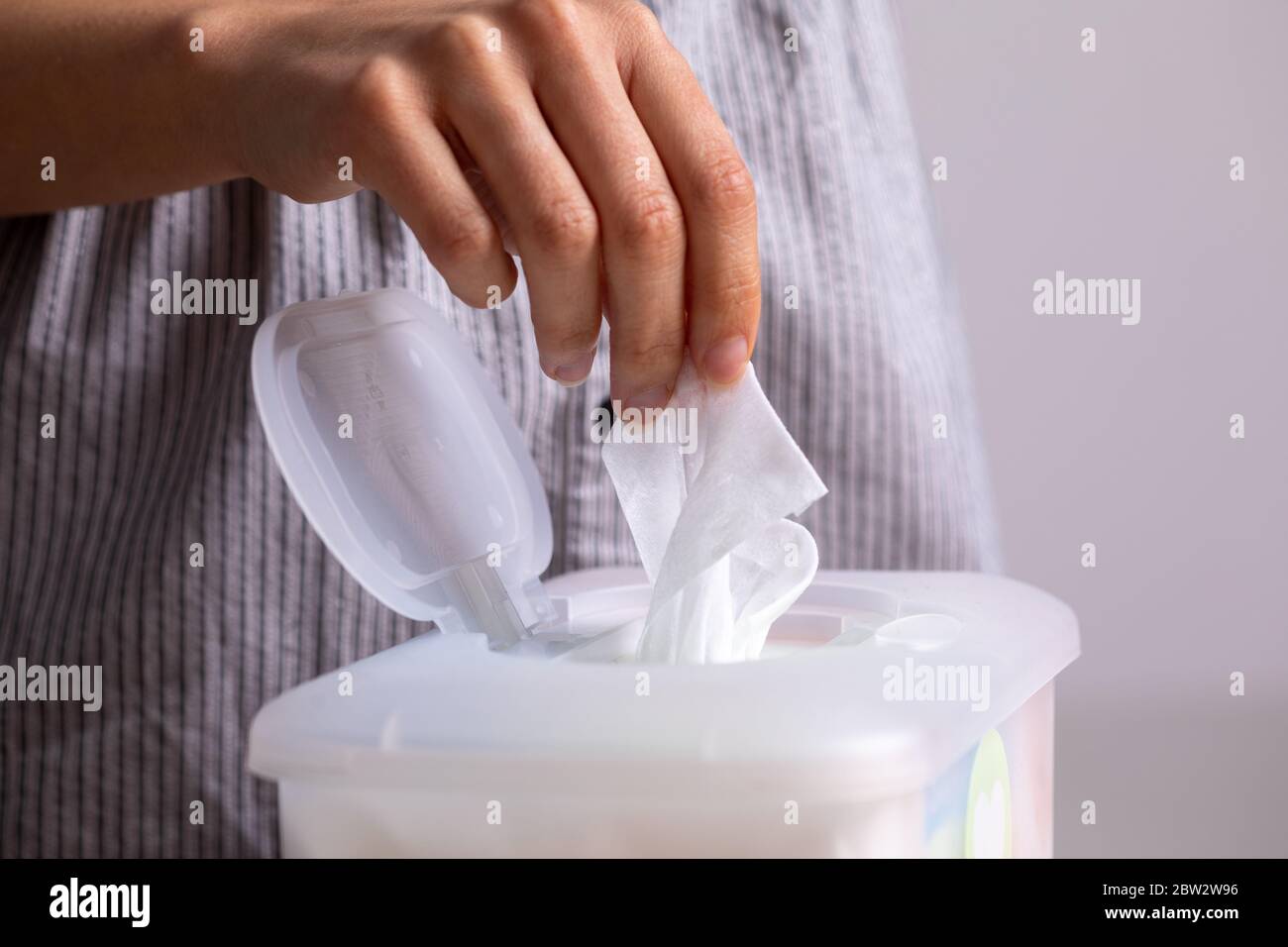 Wet wipes are universal an practical: woman hand take one wipe from big ...
