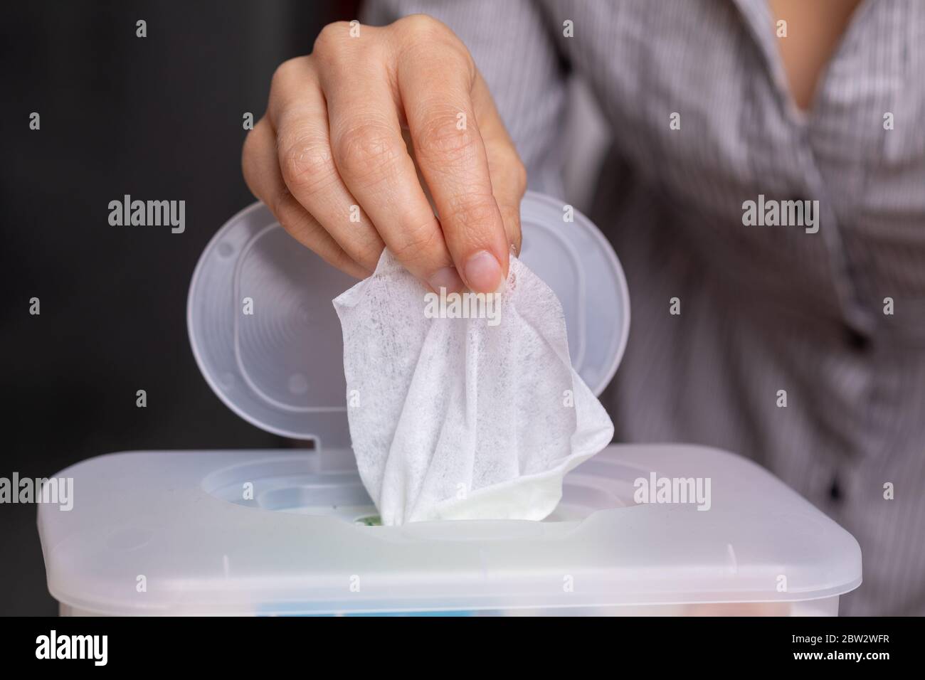 Wet wipes are universal an practical: woman hand take one wipe from big ...
