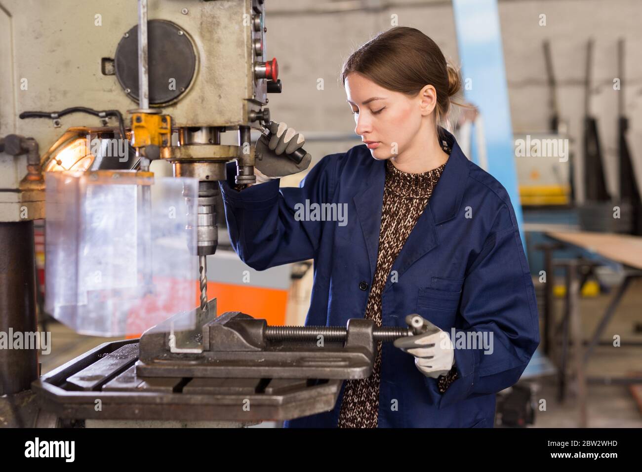 Young woman using drill machine hi-res stock photography and images - Alamy