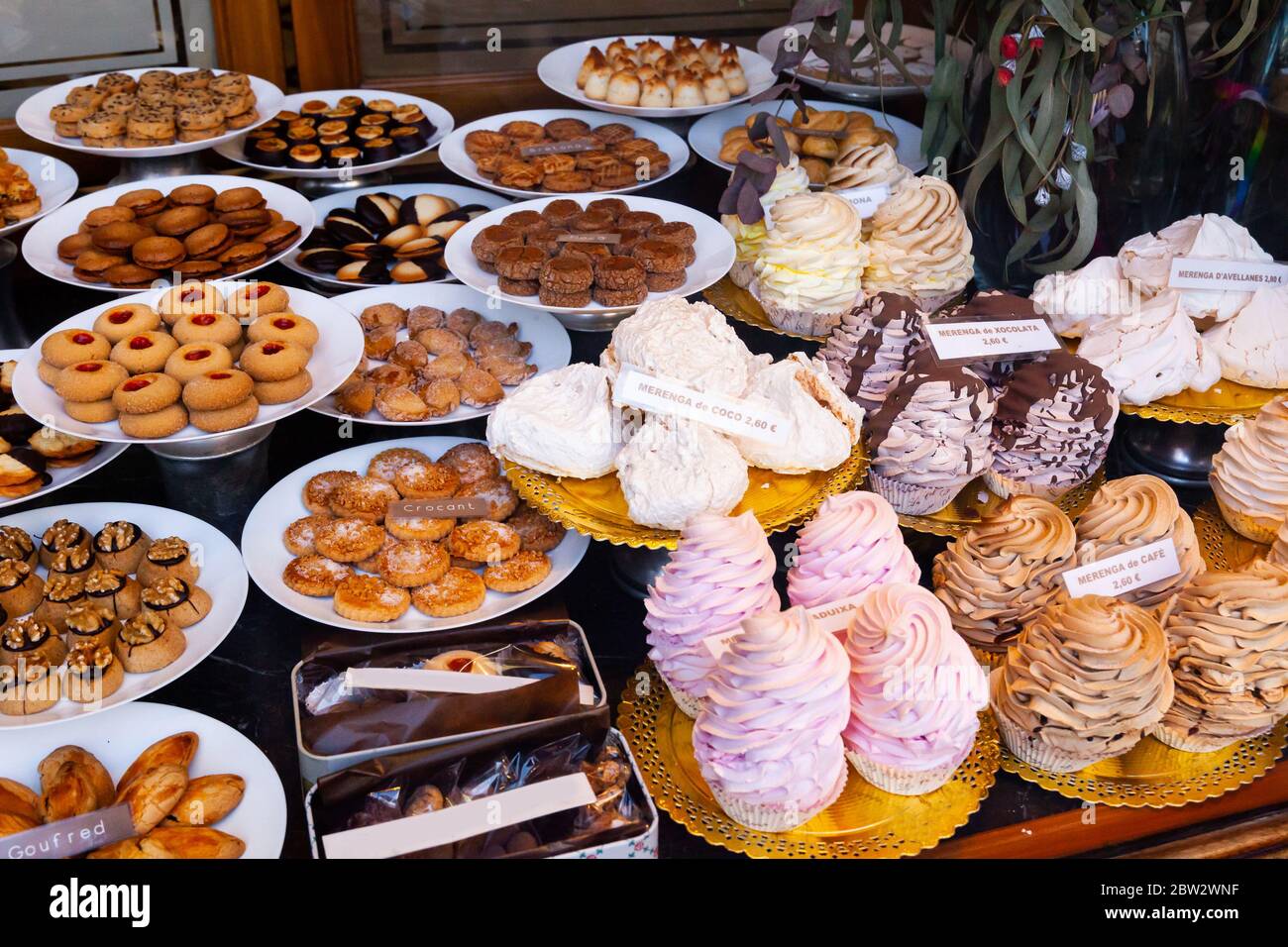 Large assortment of sweet pastries on confectionery counter with price ...
