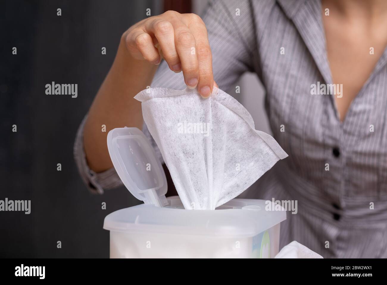 Wet wipes are universal an practical: woman hand take one wipe from big ...