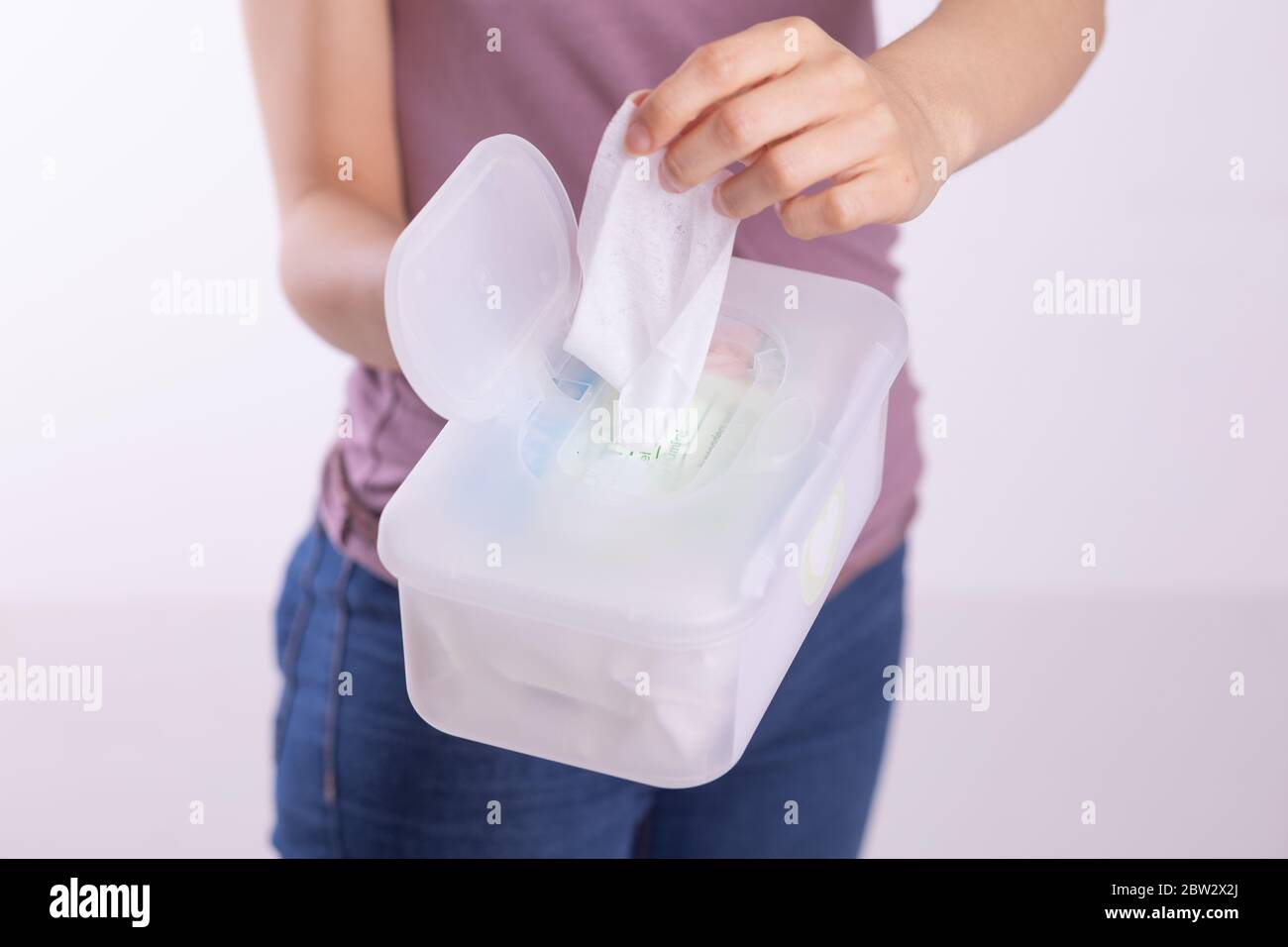 Wet wipes are universal an practical: woman hand take one wipe from big ...