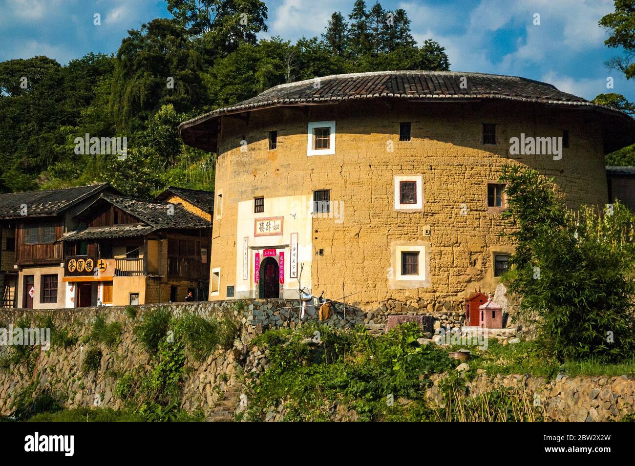 The Rusheng Lou tulou building across the river from the main group of ...