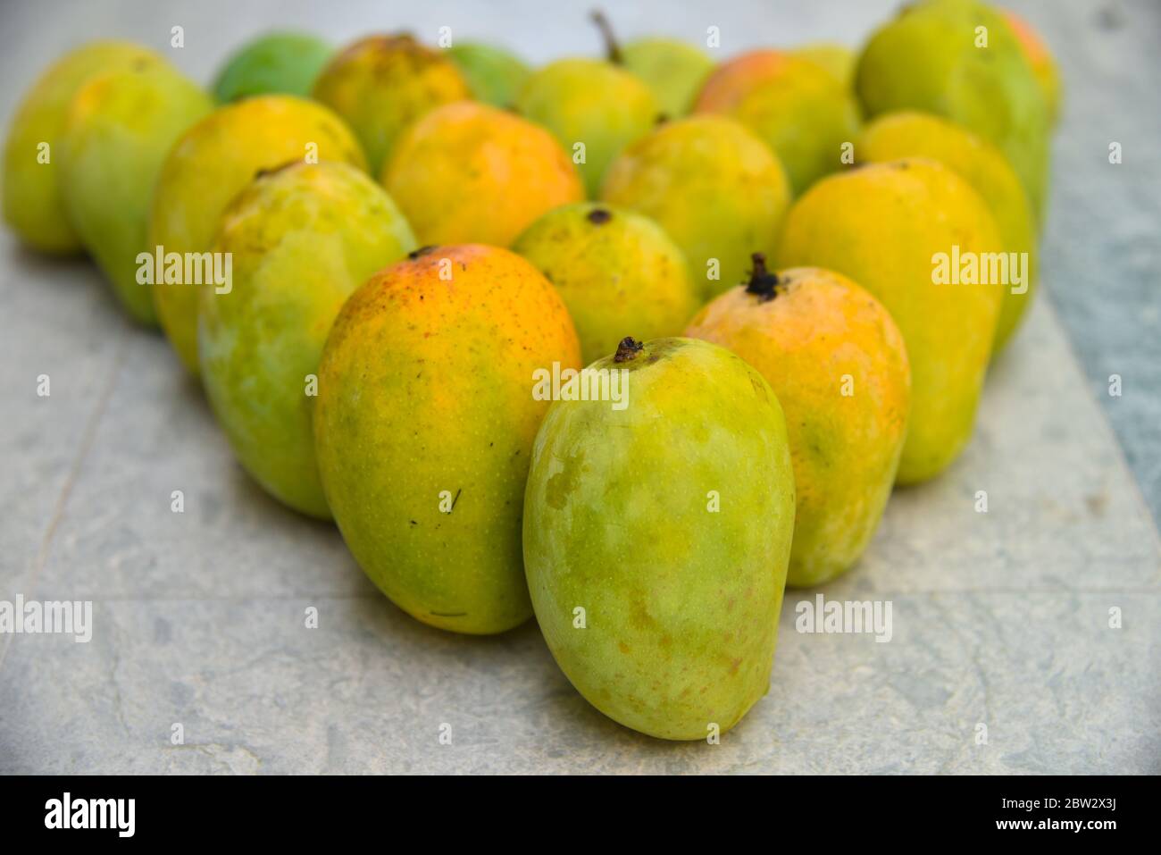 mangoes put on triangle shape close up background Stock Photo - Alamy
