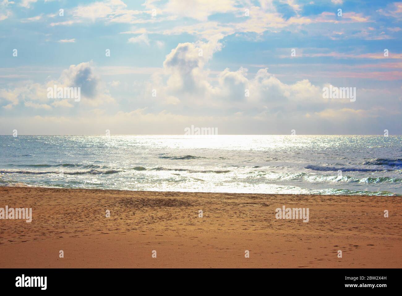 sandy beach and sunlight over the sea Stock Photo - Alamy