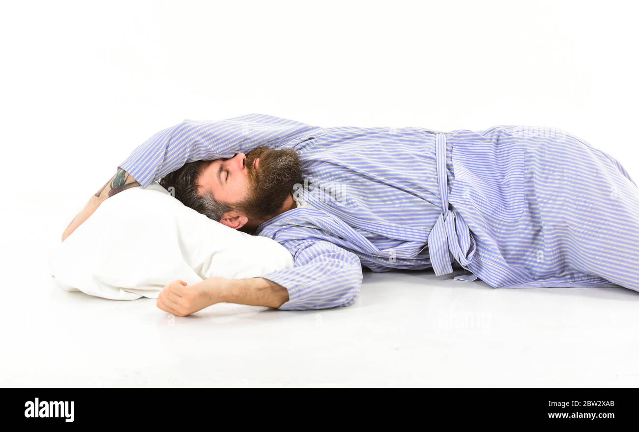 Man with sleepy face lies on pillow, sleeps. Hipster with beard and ...