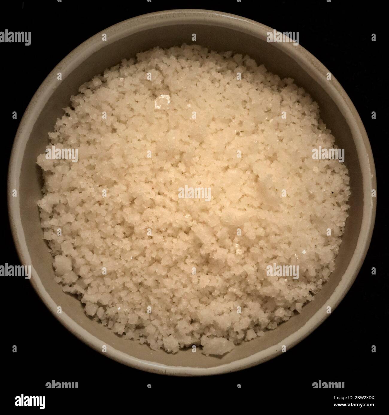 Sea salt in a small bowl Stock Photo - Alamy