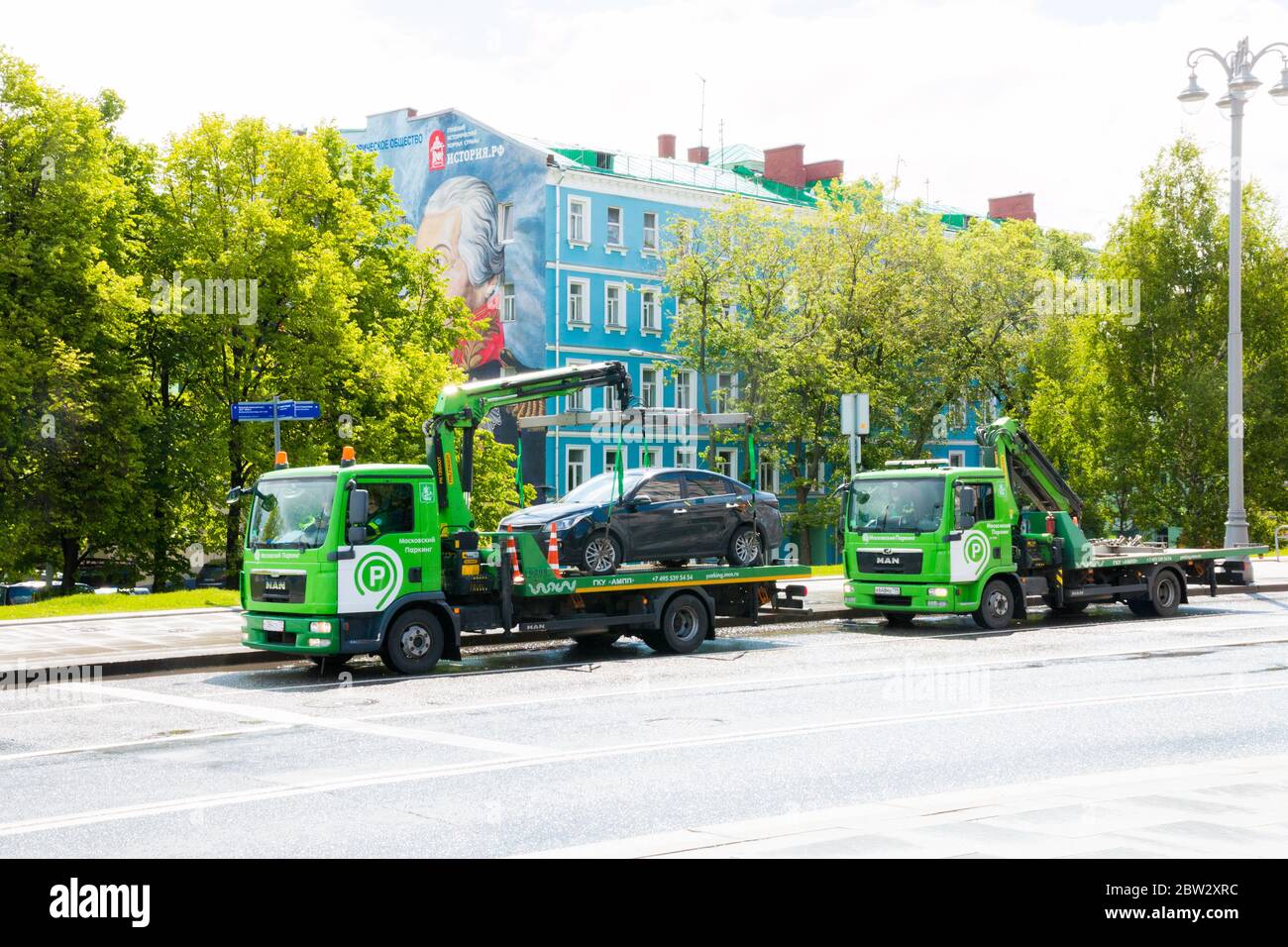 The tow truck service takes the car to the impound lot. street photo ...