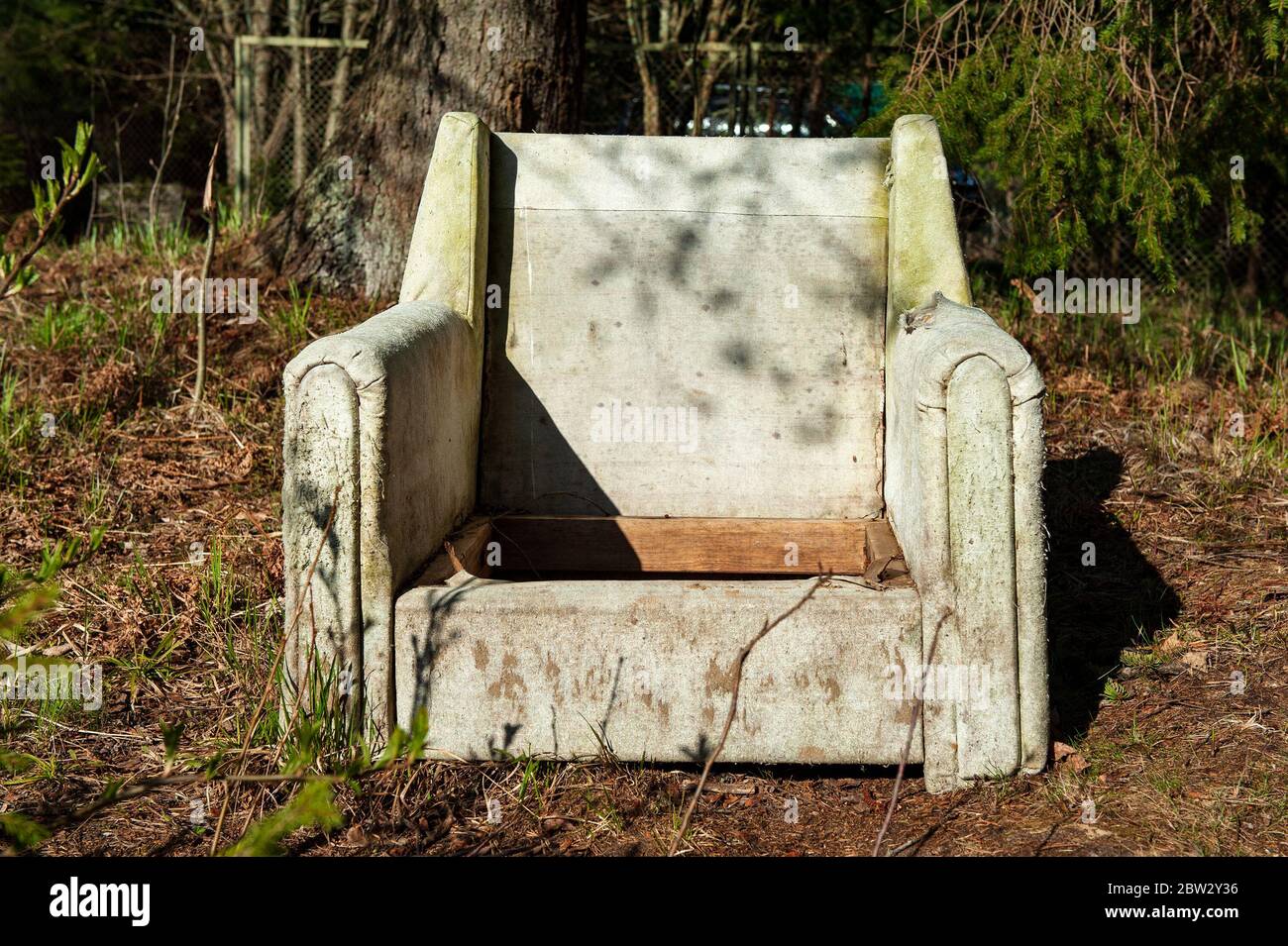 worn abandoned chair without seat in rural landscape in summer Stock ...