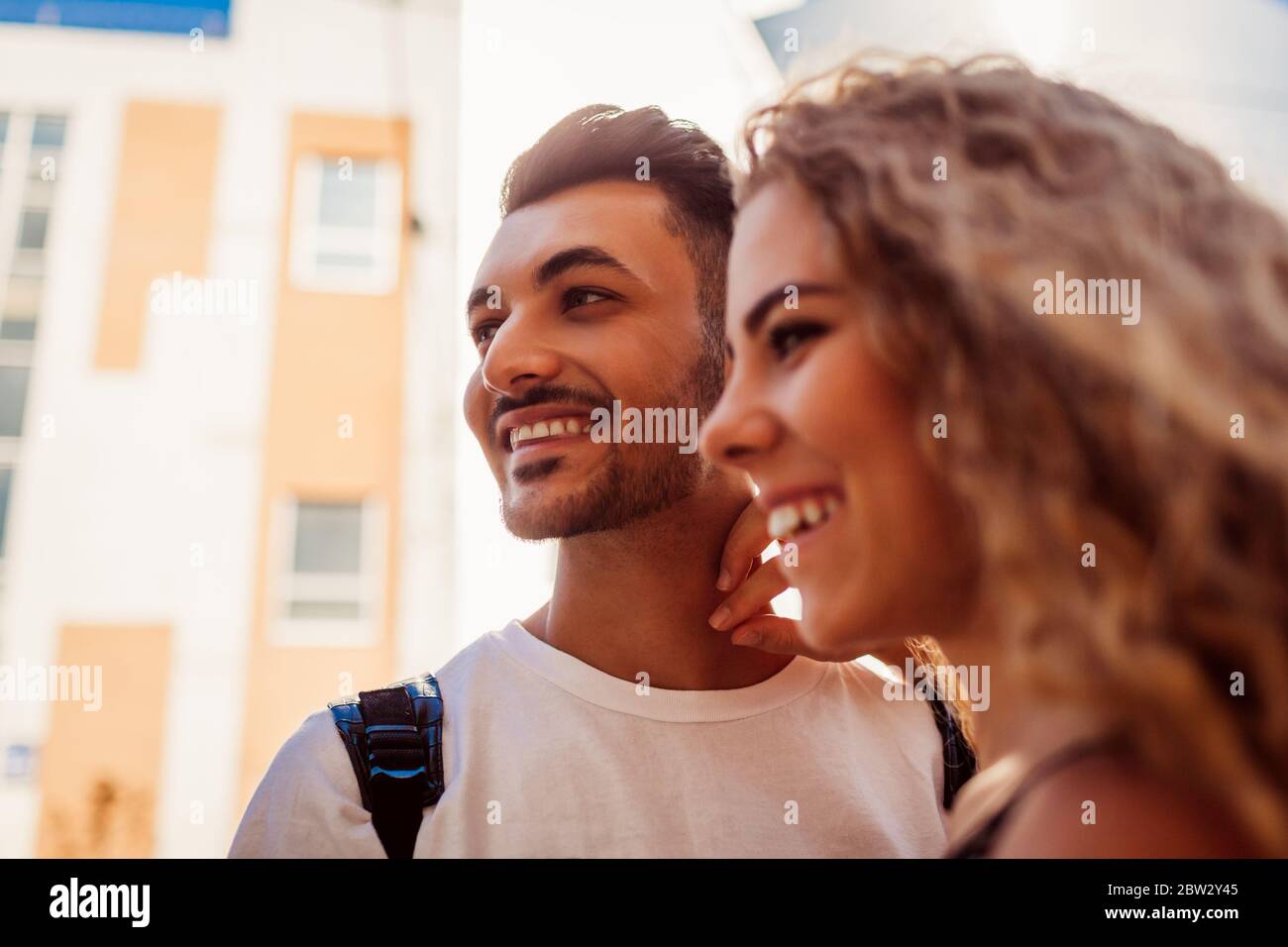Mixed race couple in love laughing outdoors. Happy arab man and white ...