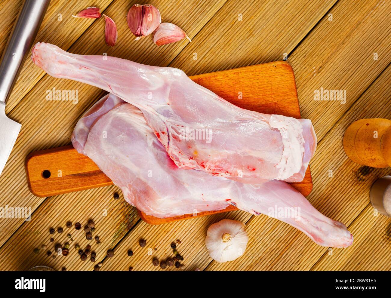 Raw goatling shoulder with rosemary and garlic. Fresh and raw meat ...