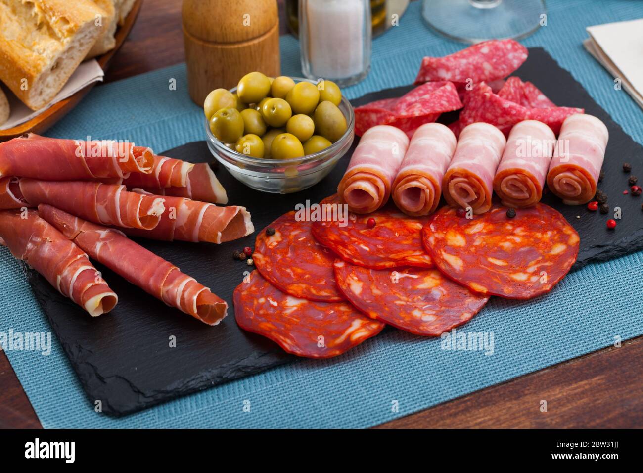 Delicious meat platter - sliced dry-cured jamon, bacon, chorizo and ...