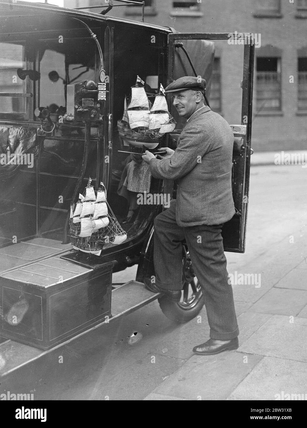 Charles Gillard , taxi driver with two models of his . 31 August 1932 ...