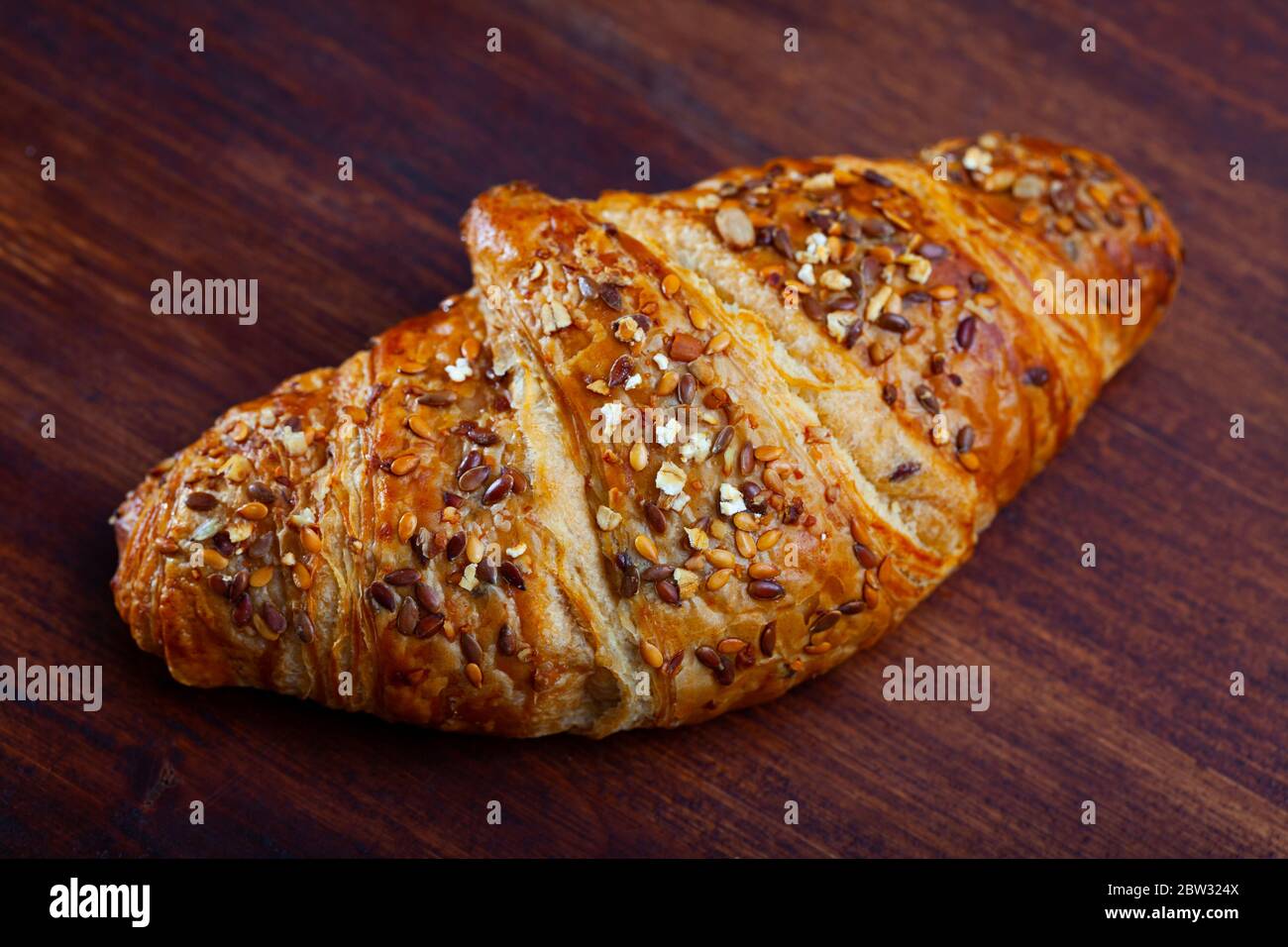 Sesame seed croissants, french dessert at wooden surface Stock Photo ...