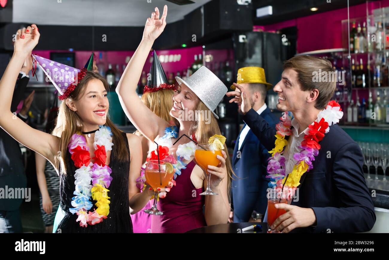 Young cheerful friends dancing on birthday party with cocktails Stock ...