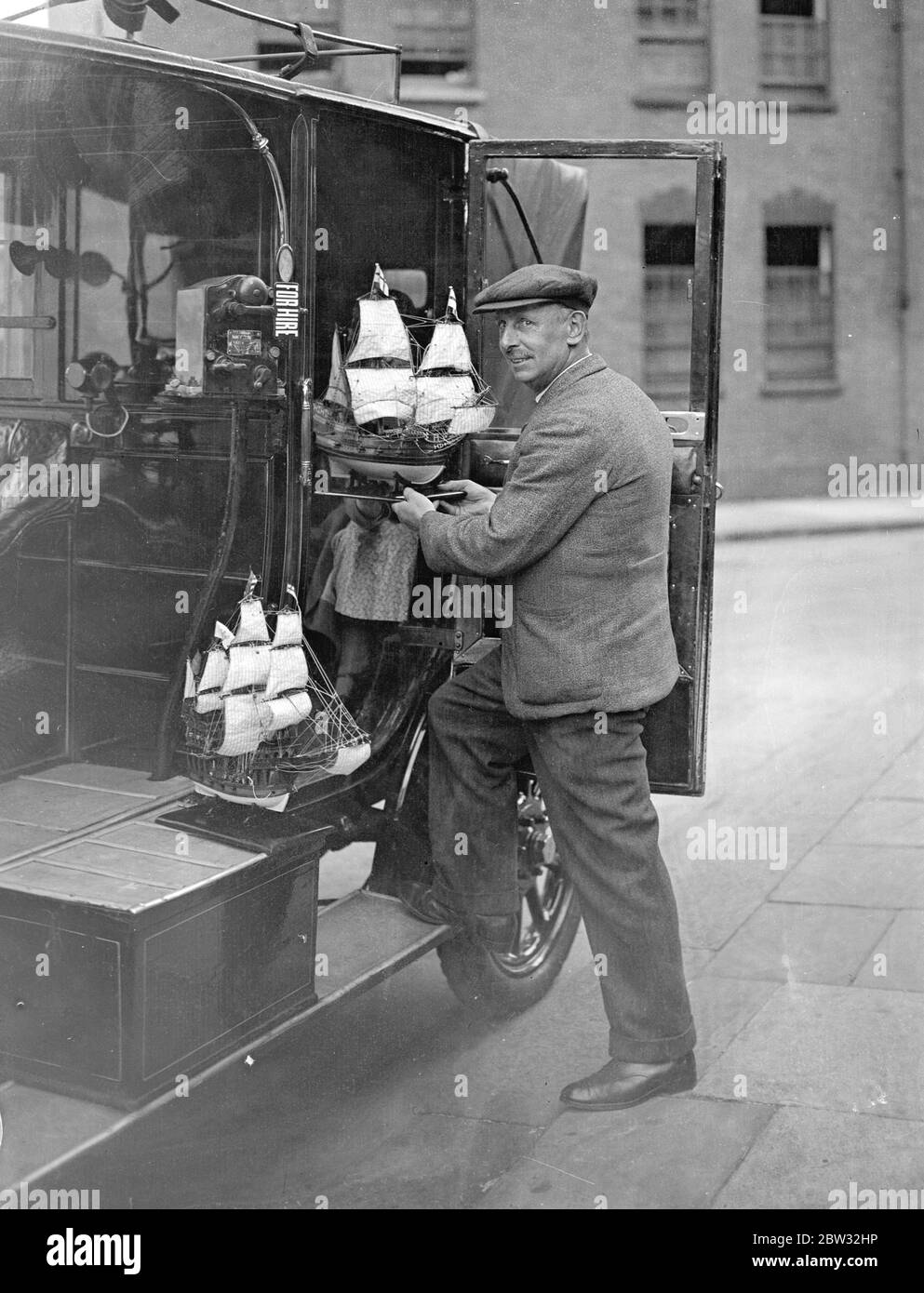 Charles Gillard , taxi driver with two models of his . 31 August 1932 ...