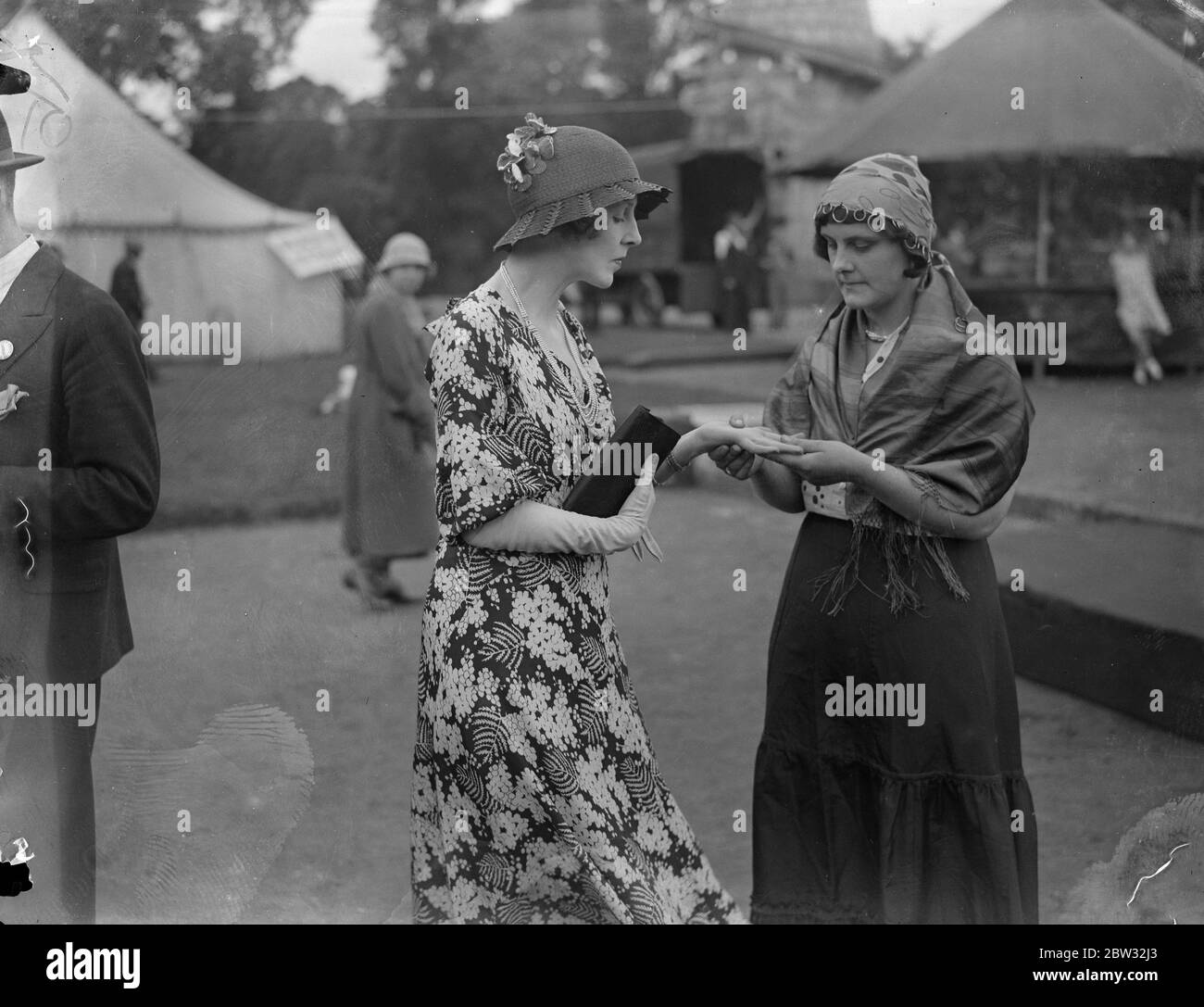 Lady Diana Cooper has her fortune told . A palmist telling the fortune ...