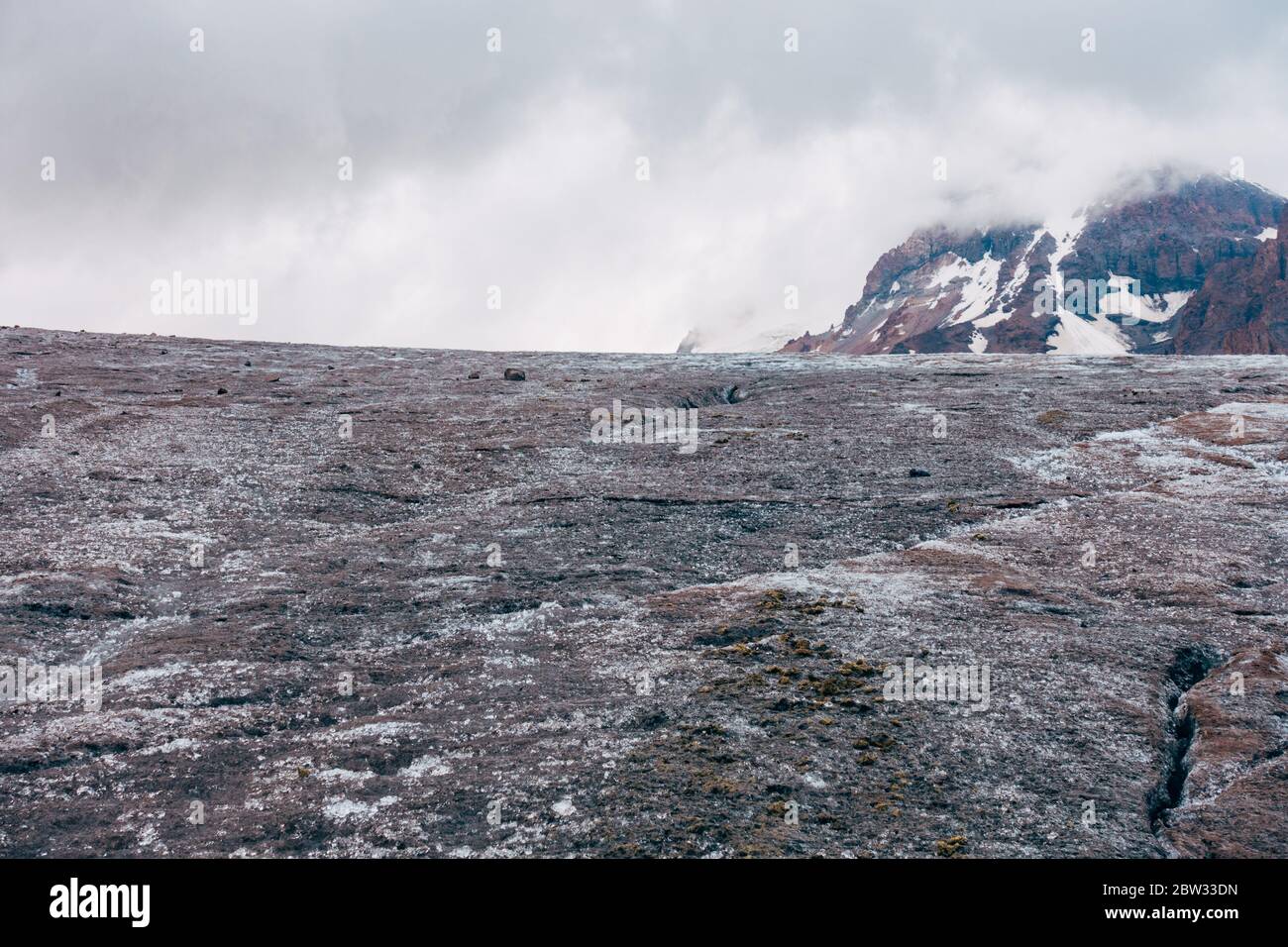 Packed ice and dirt on the Mount Kazbek glacier, Caucasus Mountains ...