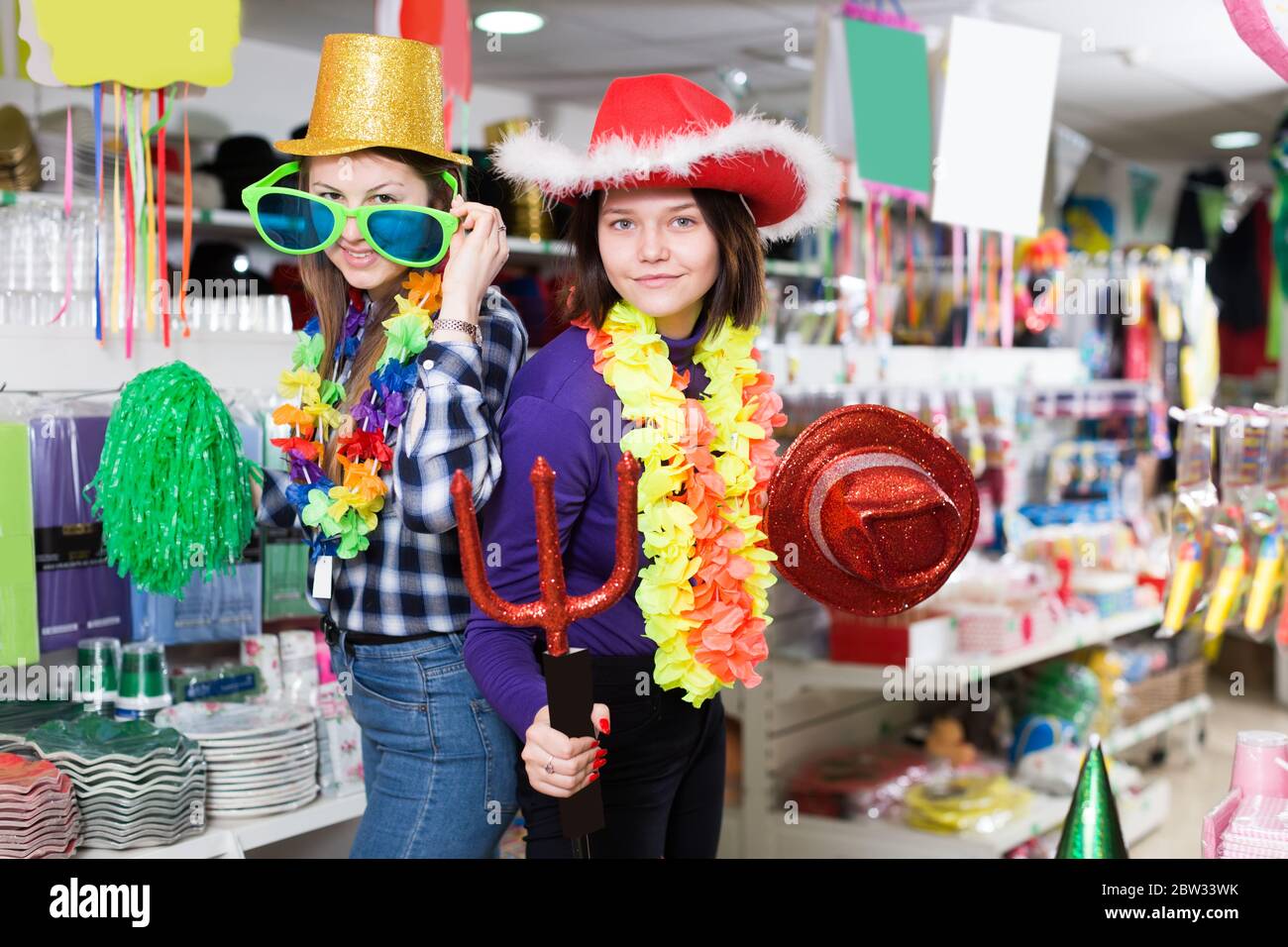 Positive girls shopping together, show funny things in store of ...