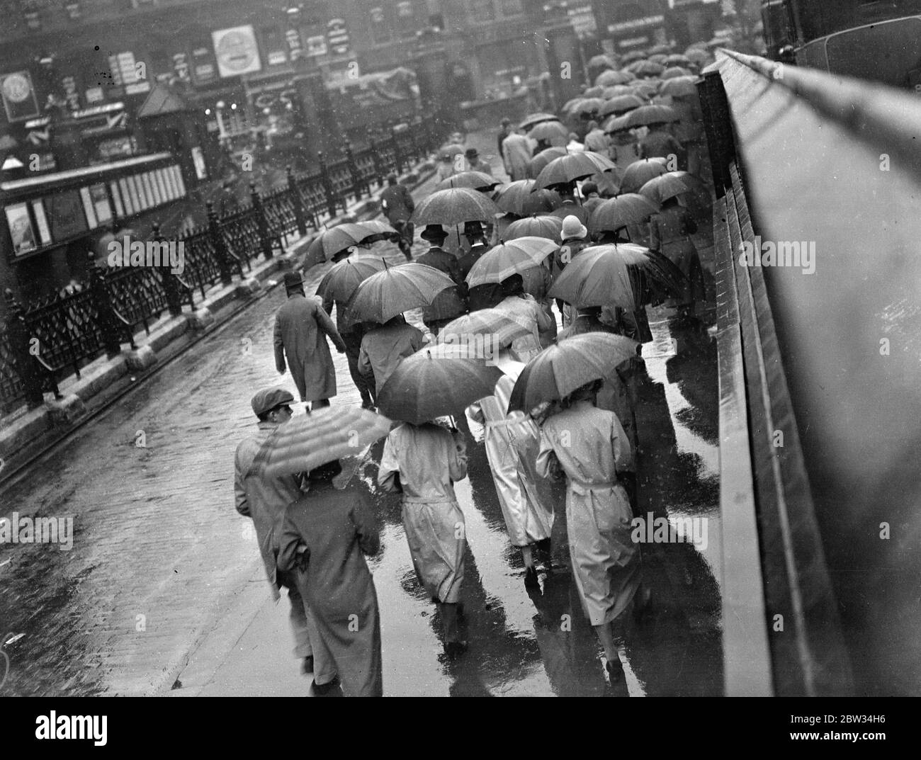 The umbrella covered crowd of workers arriving at Liverpool Street ...