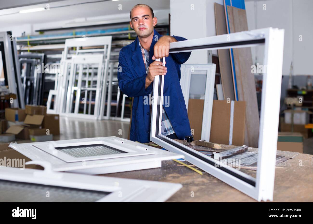 Portrait of worker assembler of plastic windows who is standing at ...