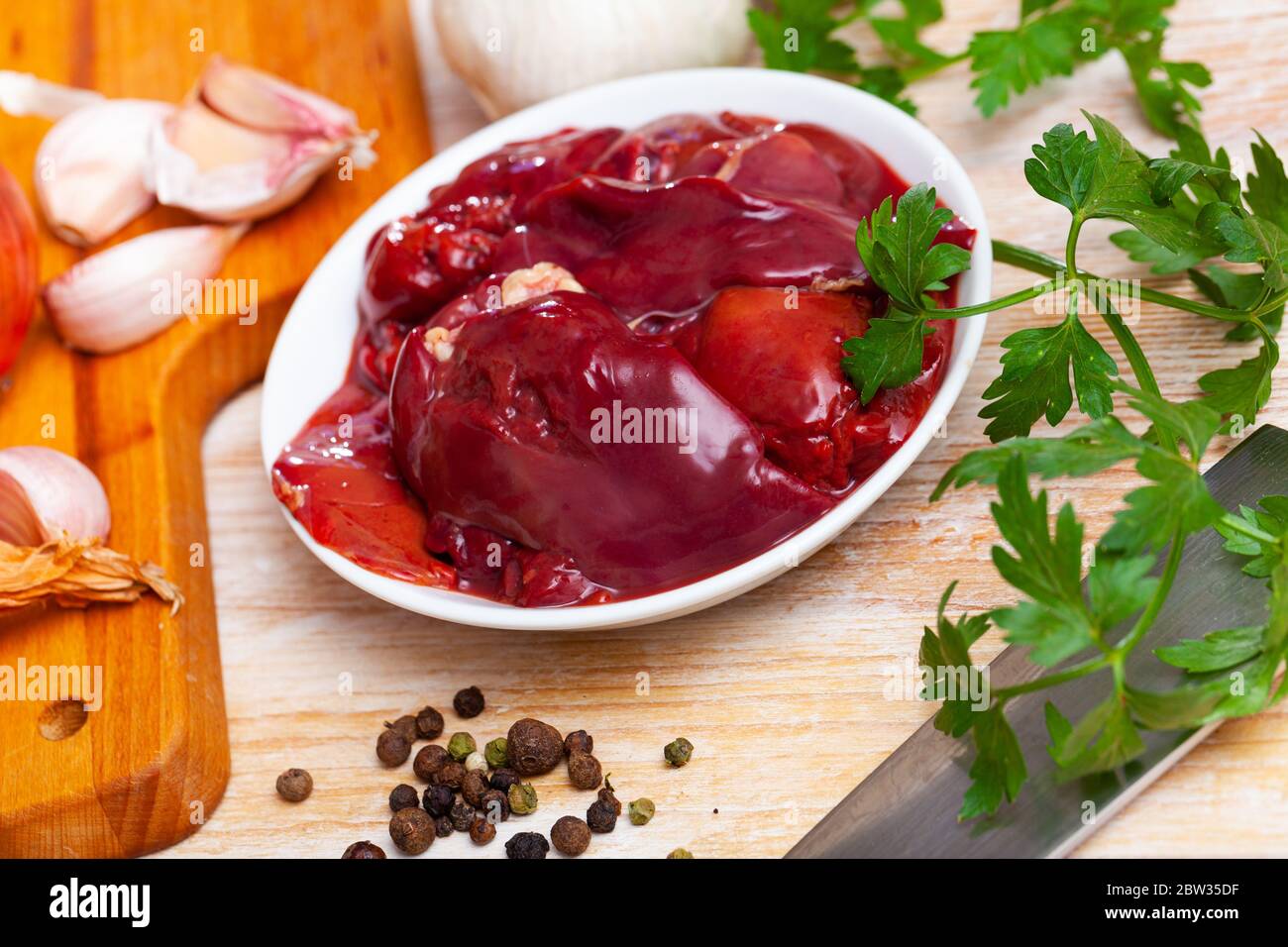 Raw poultry, fresh chicken liver with condiments on wooden table Stock ...
