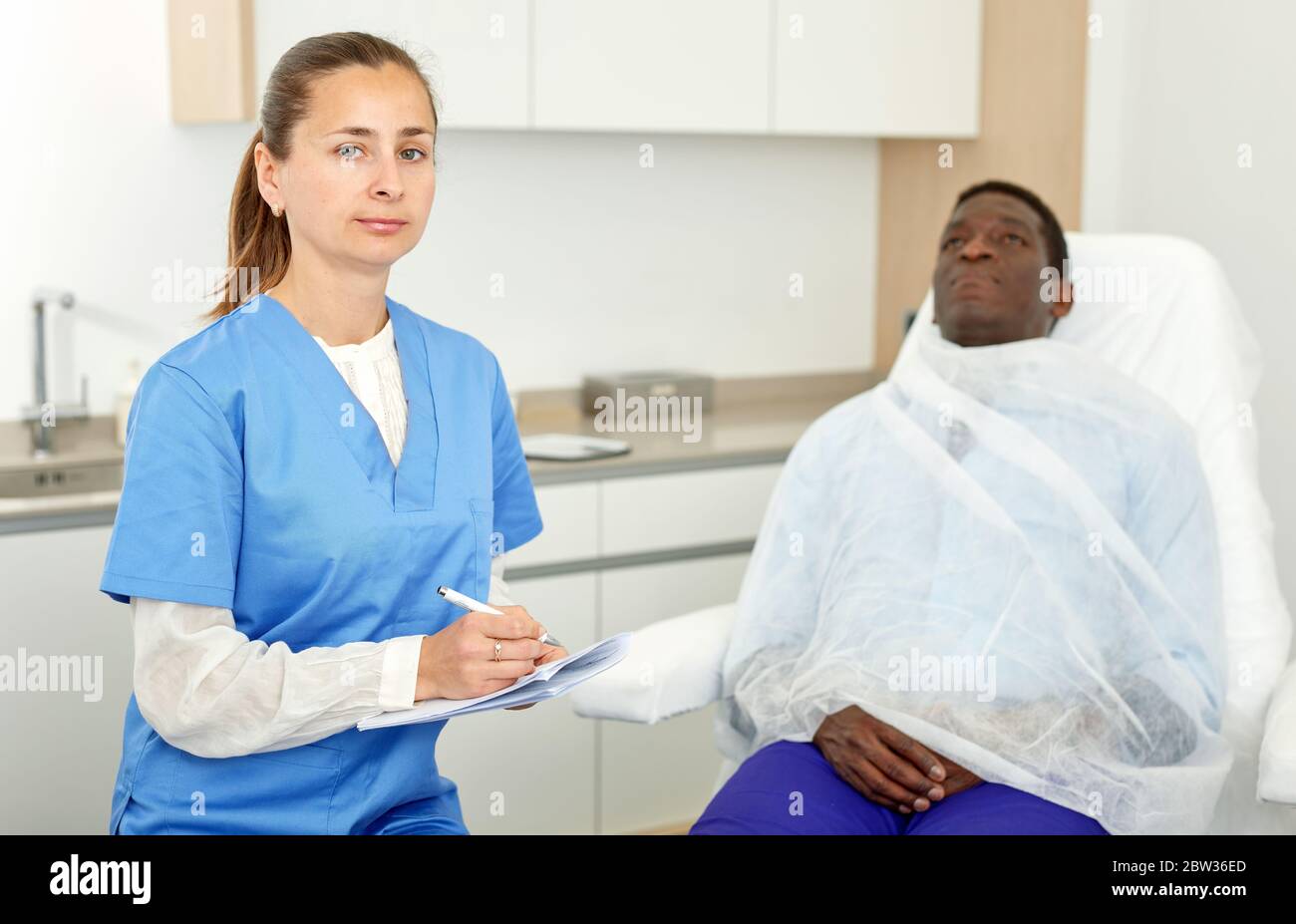 Cosmetician female signing papers before aesthetic facial procedure ...
