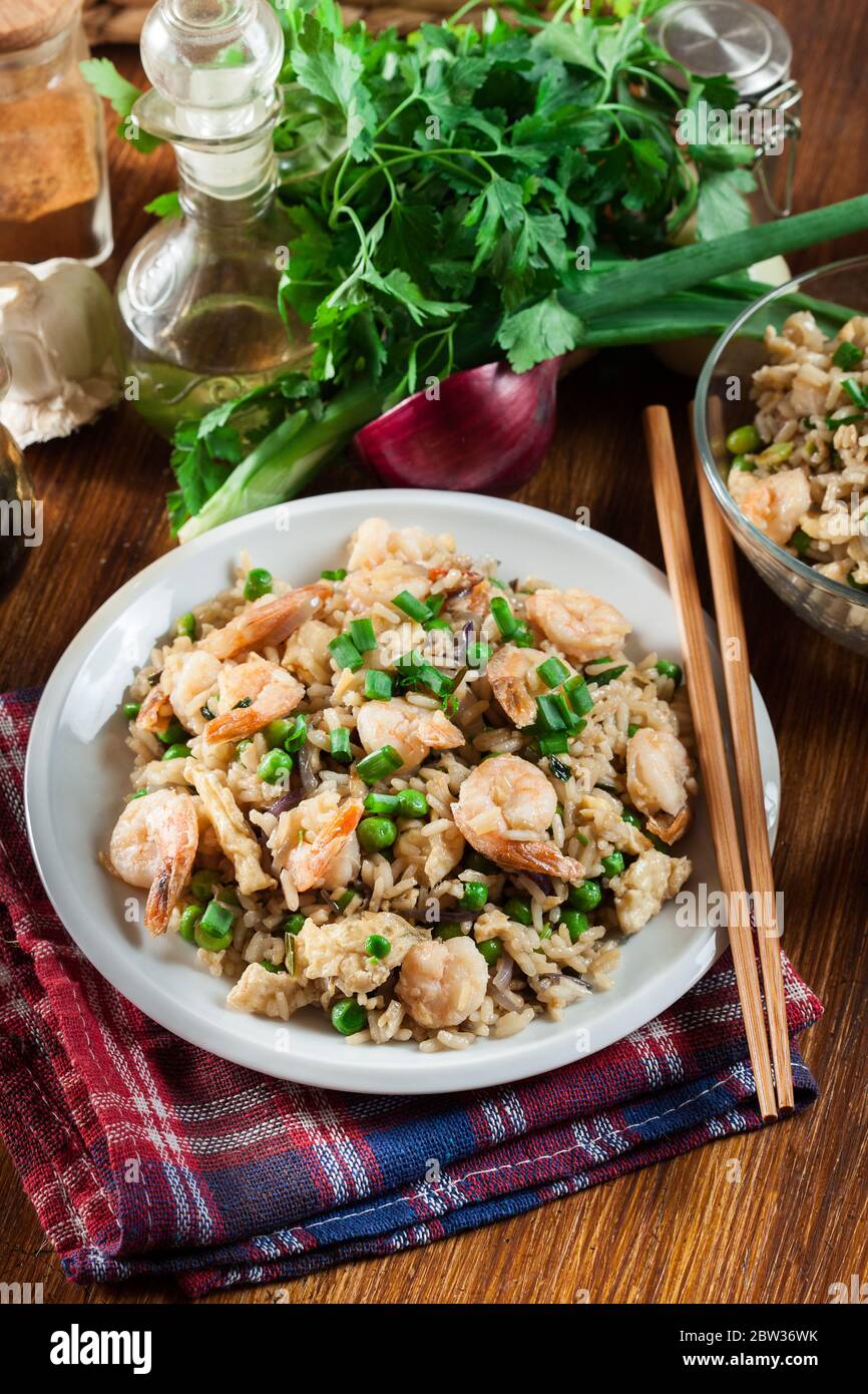 Fried rice with shrimp and vegetables served on a plate. Popular ...