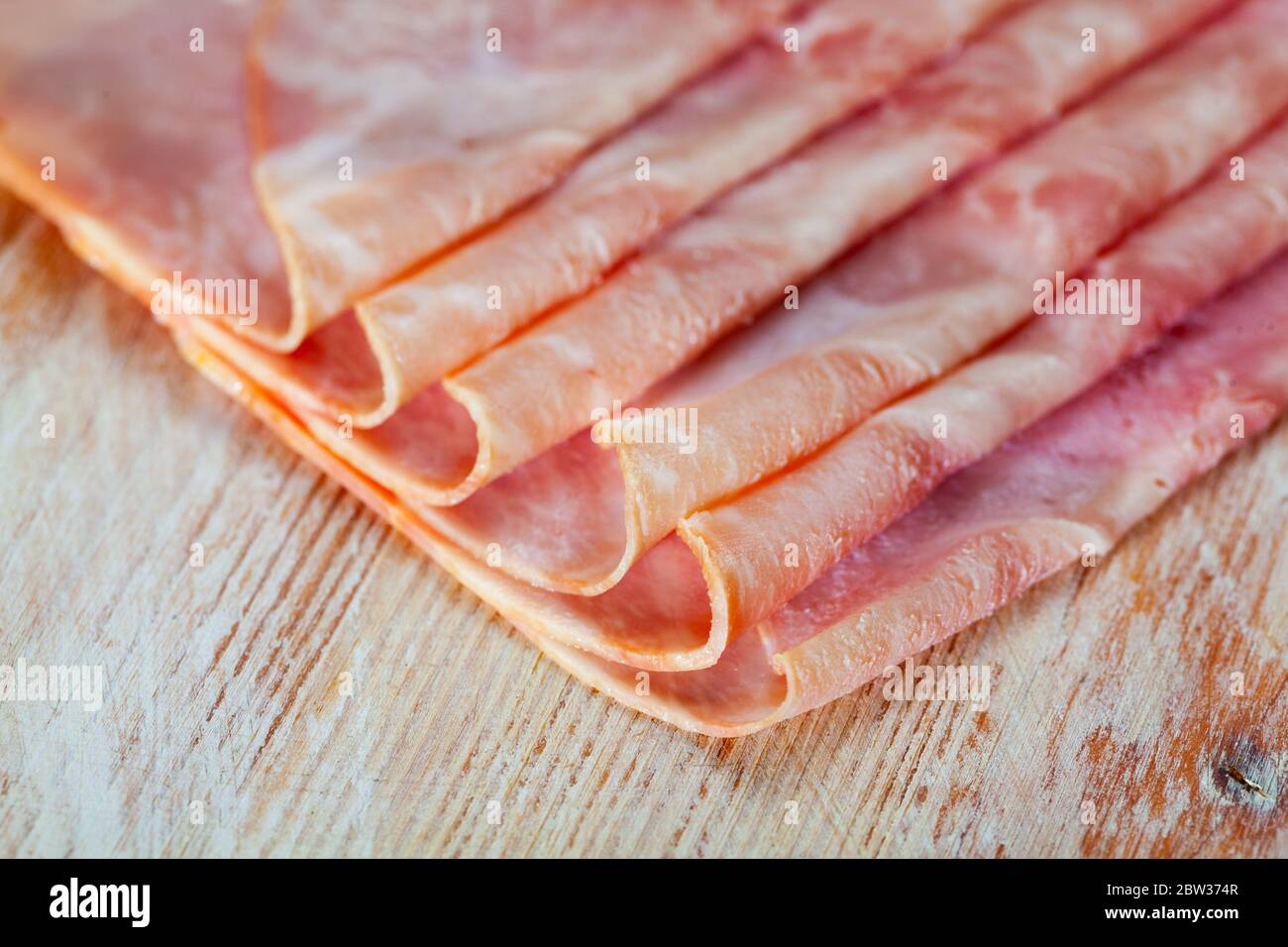 Sliced appetizing ham closeup wooden cutting board Stock Photo - Alamy
