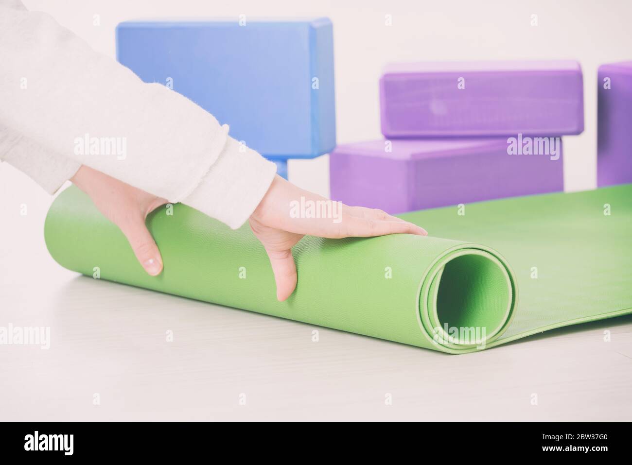 Rolling up yoga mat hi-res stock photography and images - Alamy