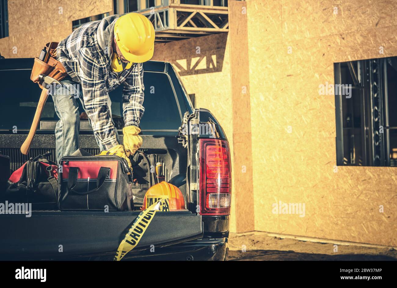 Caucasian Contractor in His 30s Cleaning His Pickup Cargo Bed. Business ...