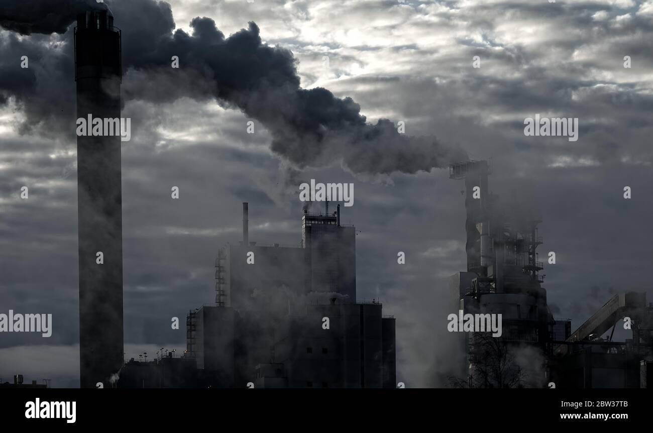 Thick clouds of dirty smoke from plant pollute atmosphere. Problems of ...
