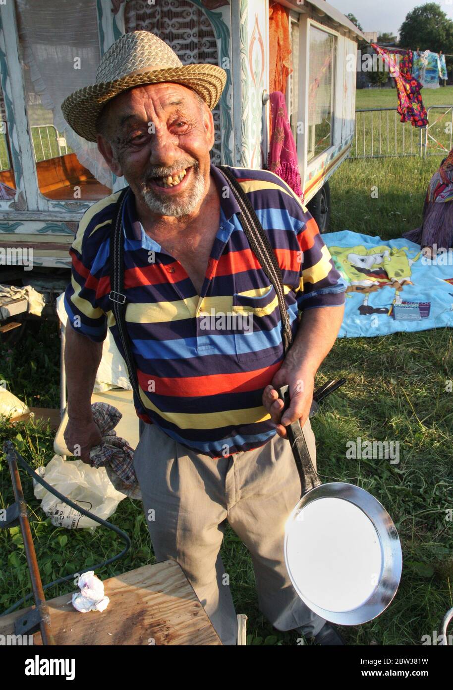Cracow. Krakow. Poland. Old Gypsy craftsman, tinsmith tiining the iron ...
