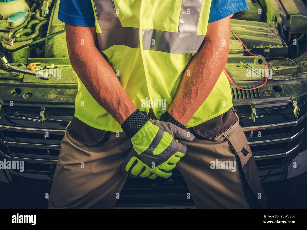 Caucasian Automotive Car Mechanic in Front of Vehicle. Lower Body ...