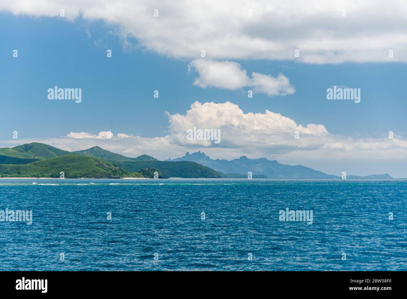 View from the turquoise sea along tropical islands. Hilly island in the ...