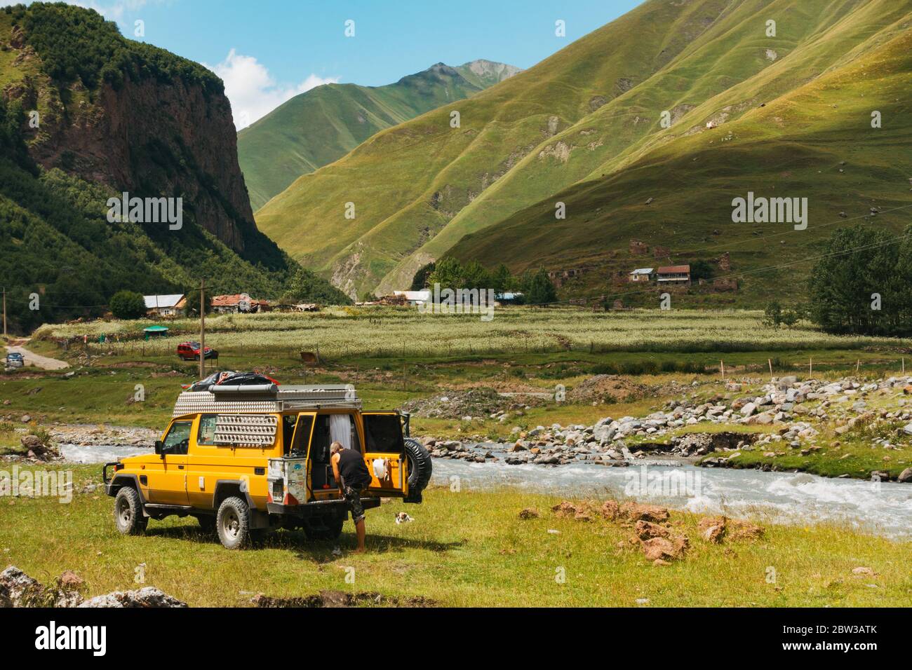 A man and a Land Cruiser camper taking a break in Truso Gorge, on the ...